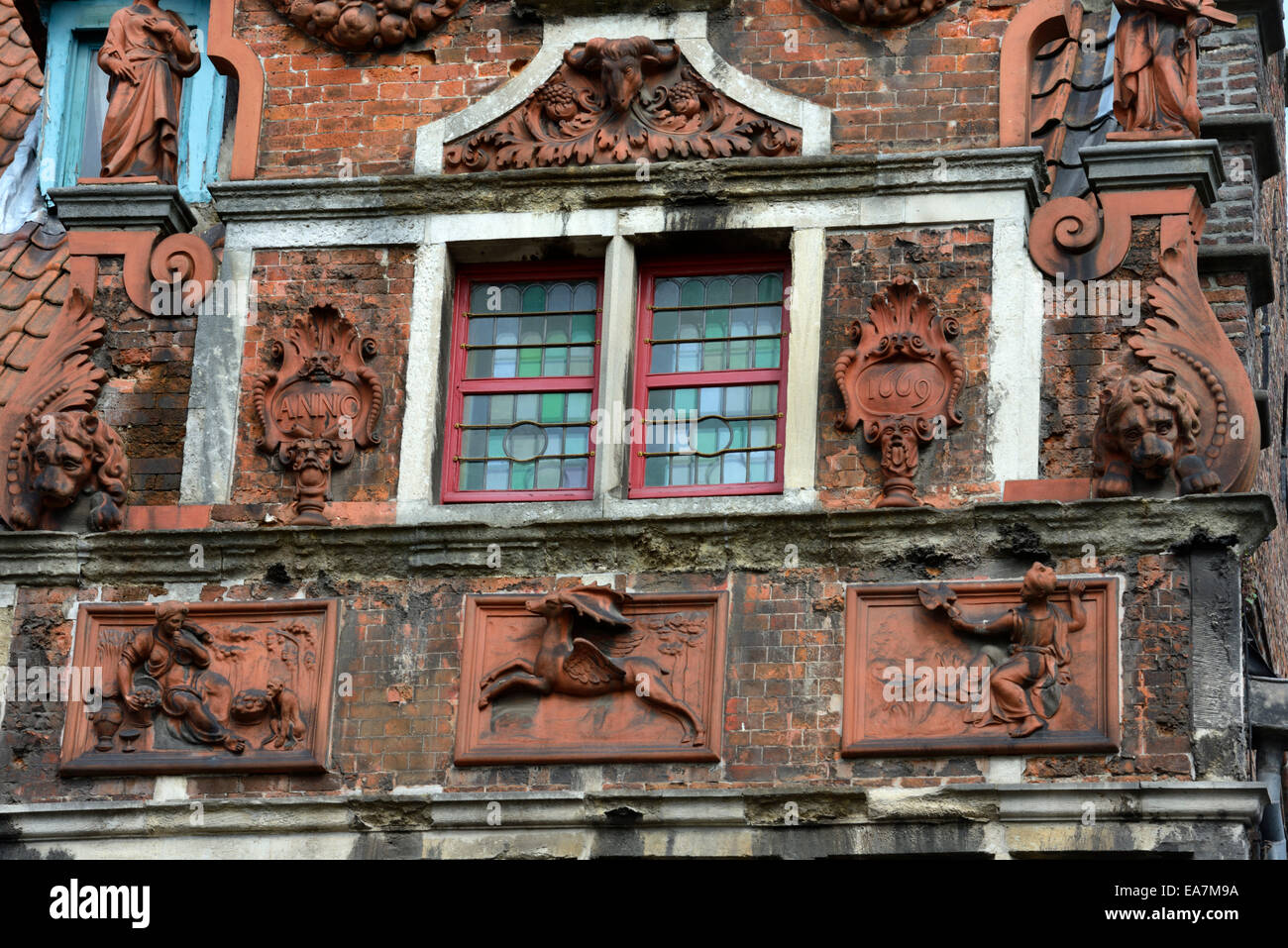 Ornate carved frontage and colured leaded windows on a traditional ...