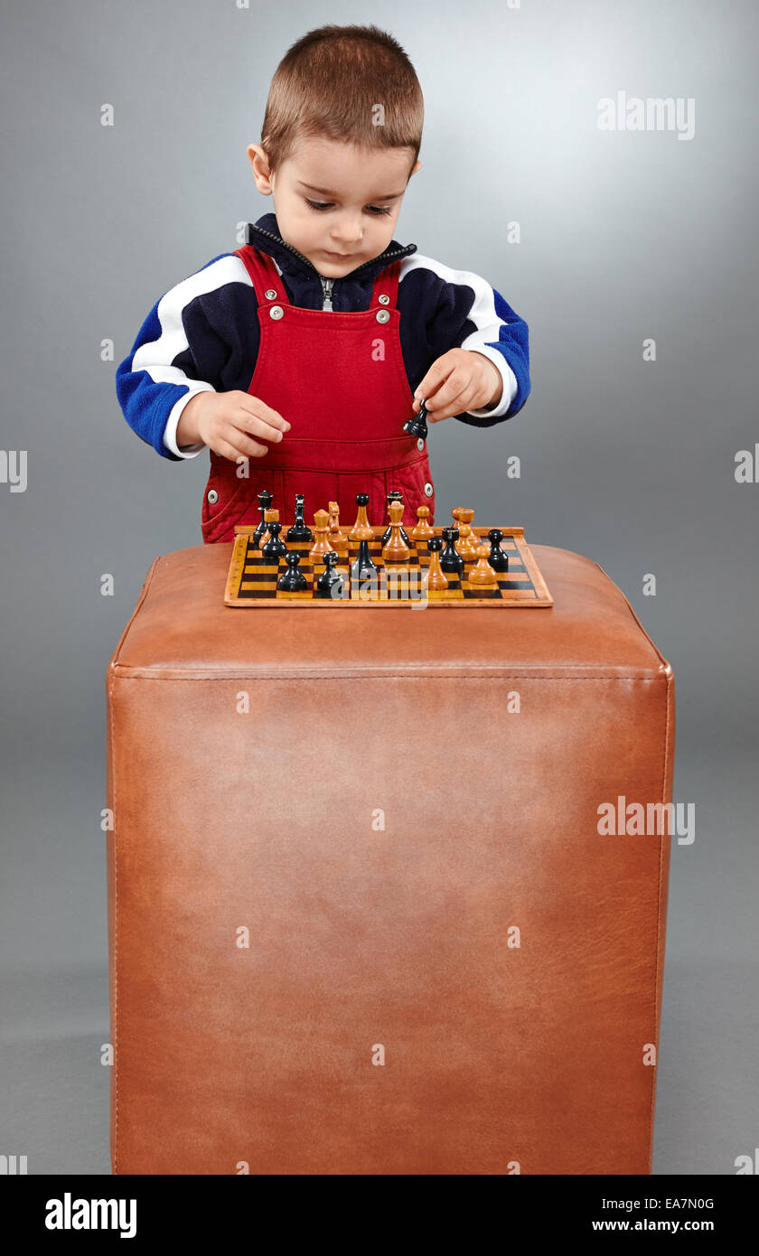 Adorable little boy learning how to play chess Stock Photo - Alamy