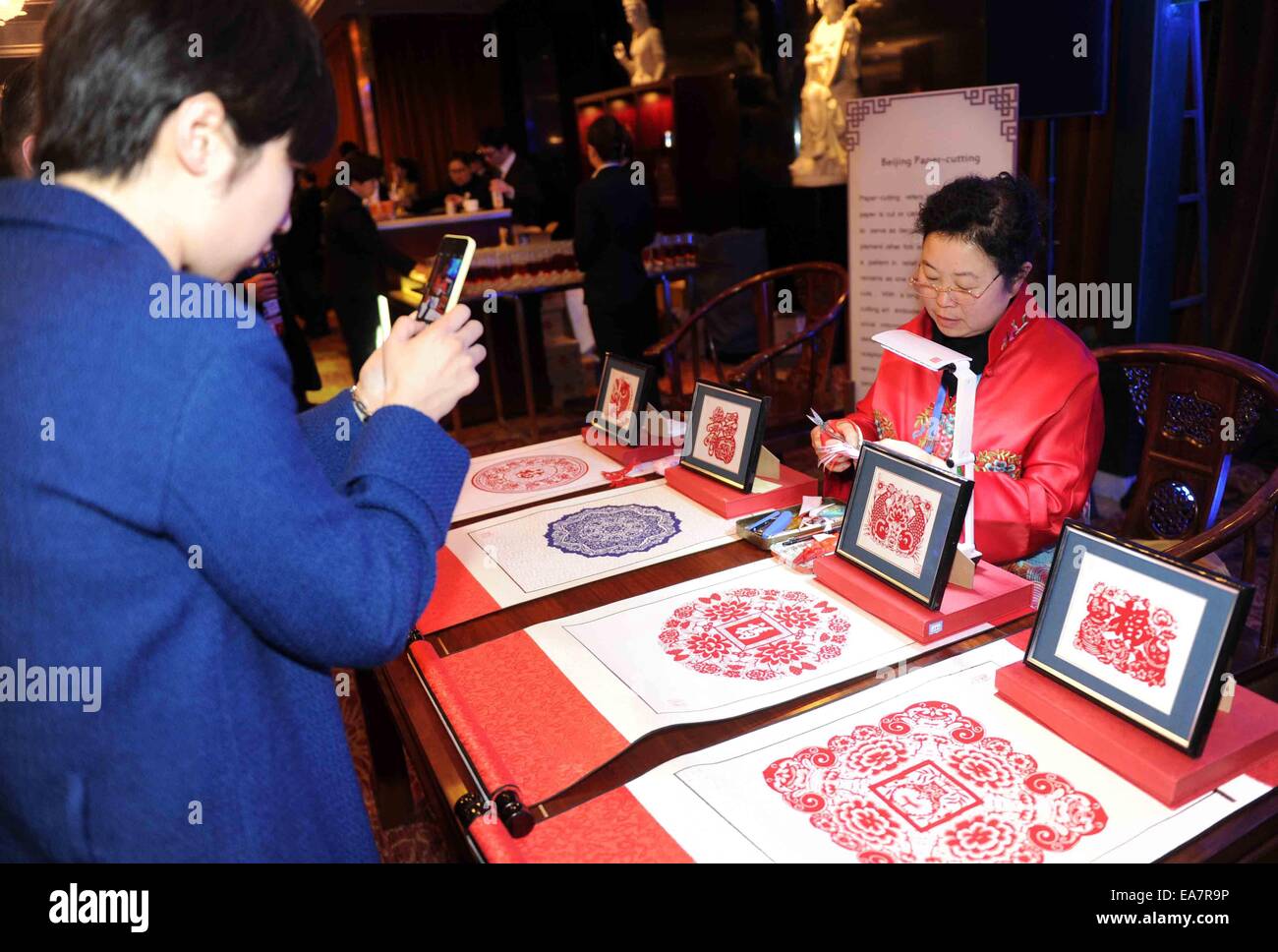 Beijing, China. 8th Nov, 2014. A guest takes photos of making paper ...