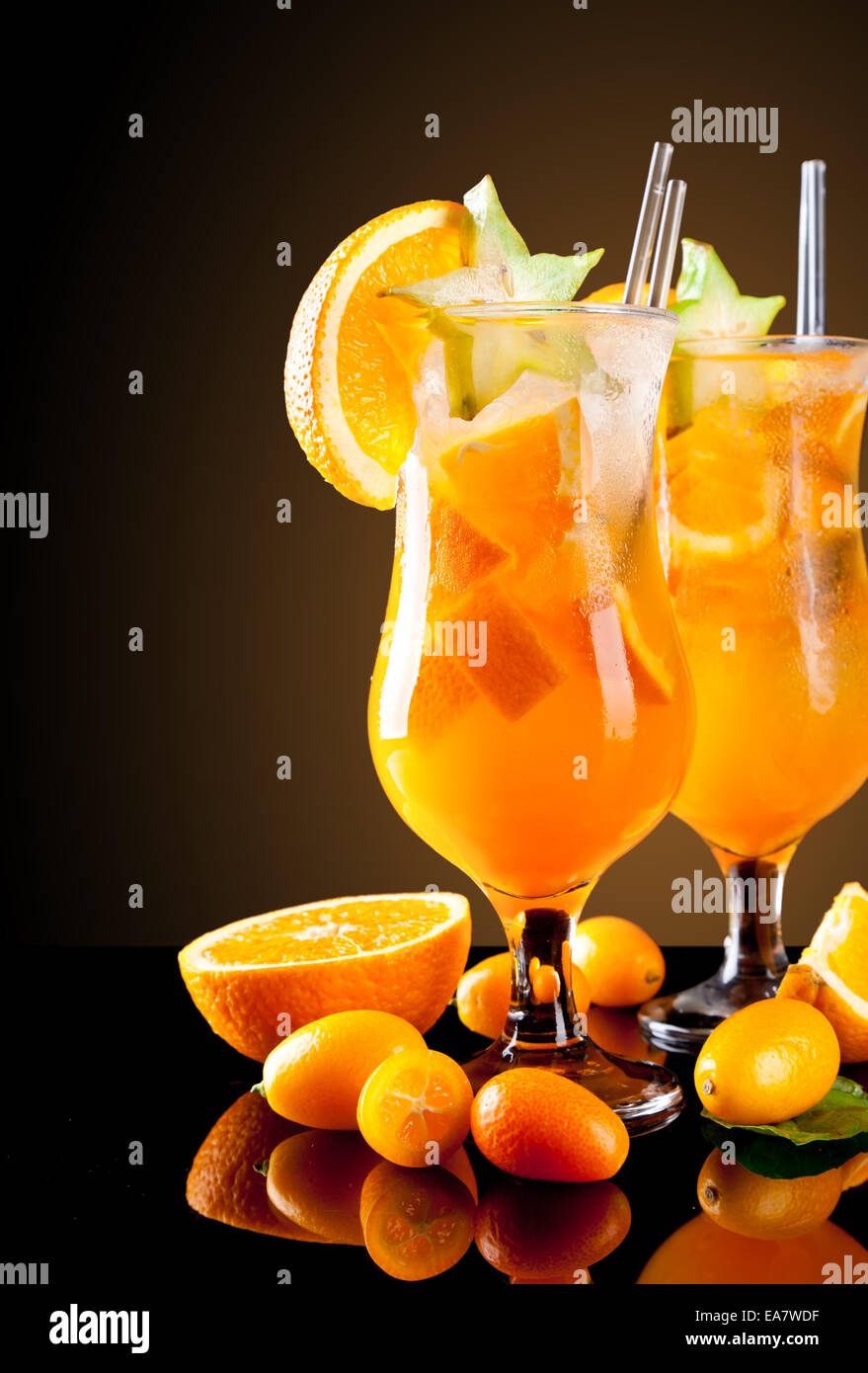 Fresh orange cocktails with fruit, isolated on black background Stock ...