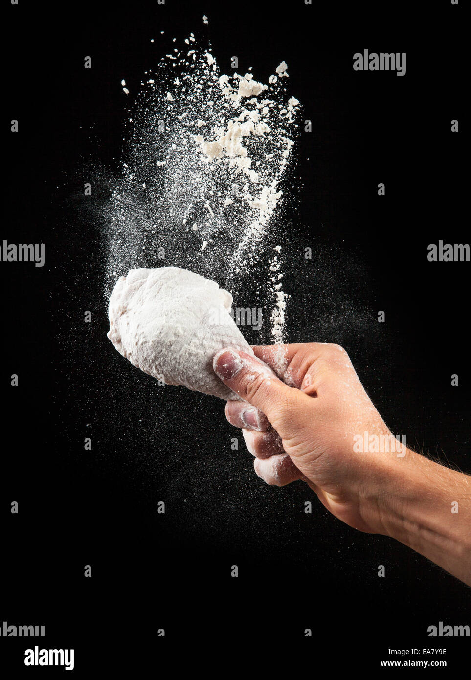 Chicken leg with flour in freeze motion, isolated on black background ...