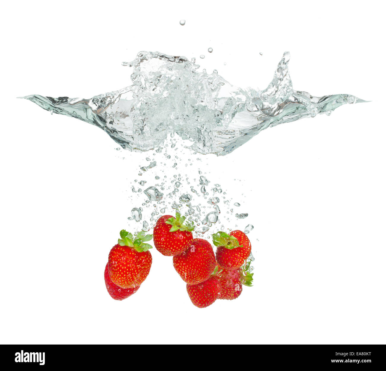 Isolated shot of strawberry falling into water, isolated on white ...