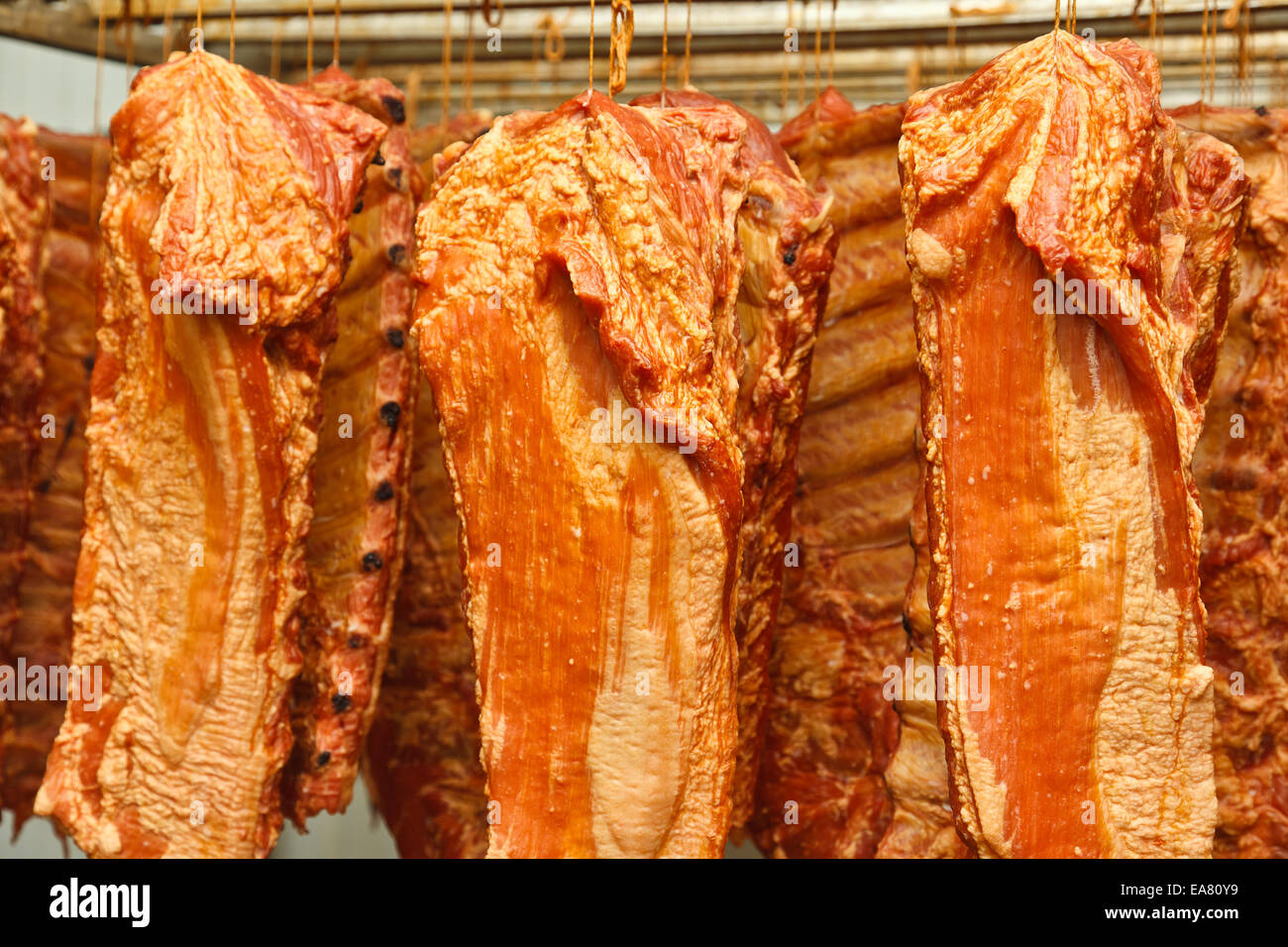 Lots of hanging smoked pork ribs on stock Stock Photo - Alamy