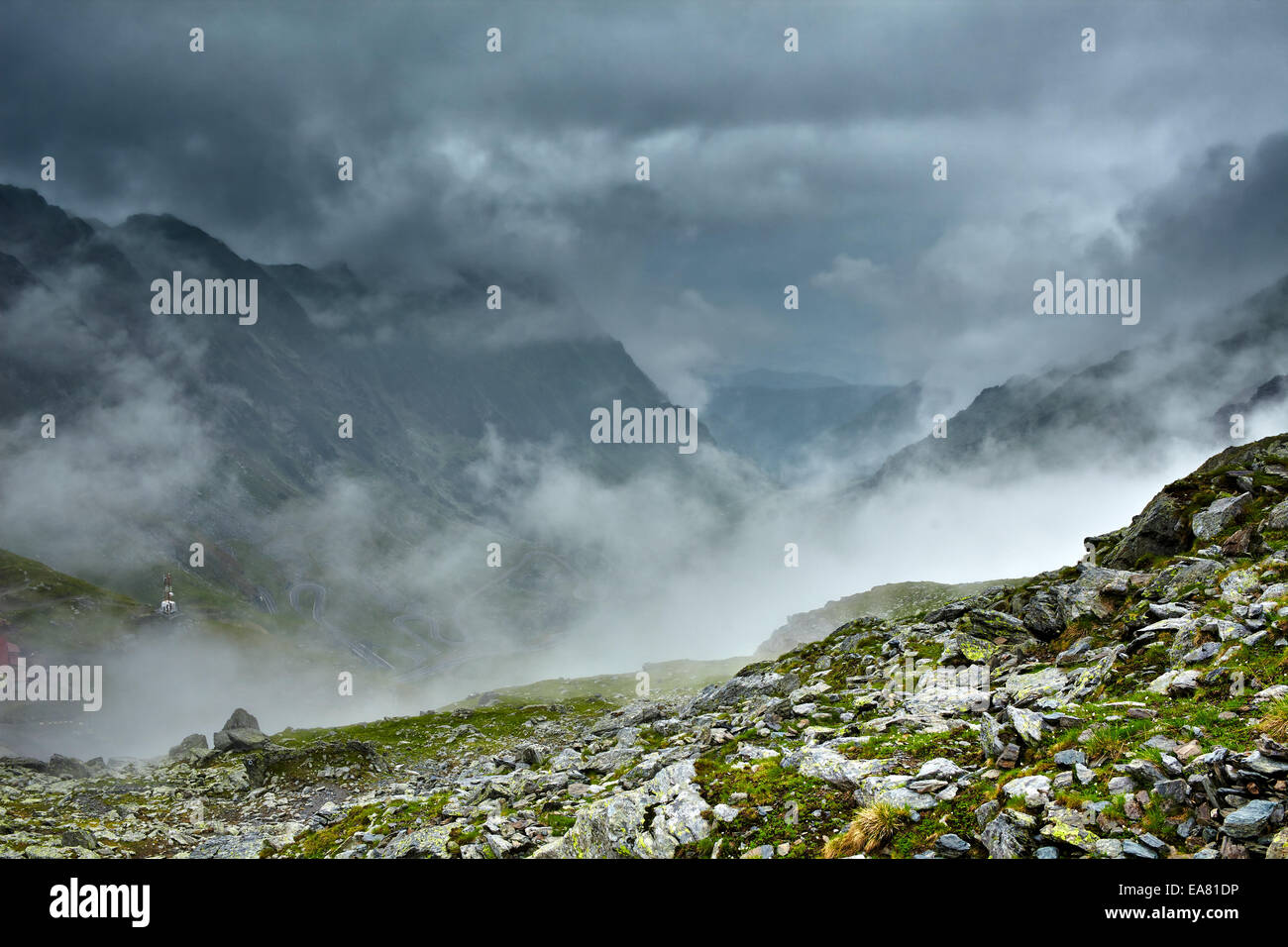 Alpine landscape with mountains and slopes in the mist Stock Photo - Alamy