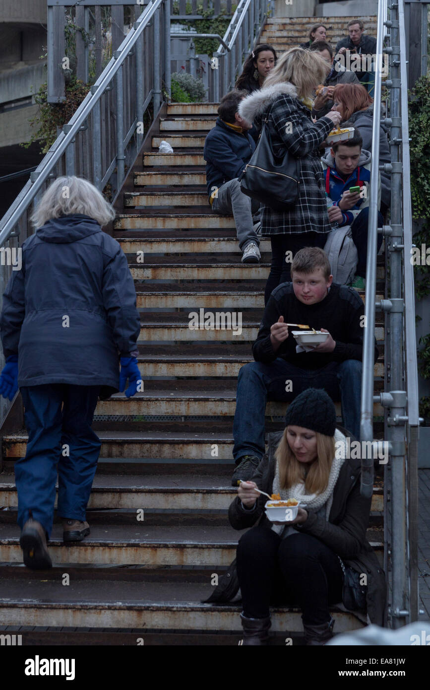 People eating on the stairs at the Real Food Market. Held weekly ...