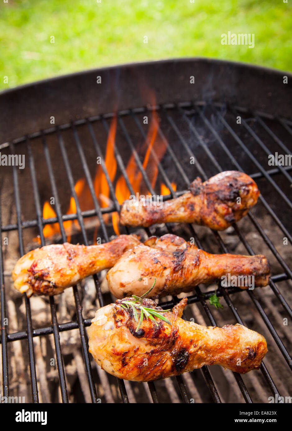 Grilled chicken legs on fire Stock Photo - Alamy