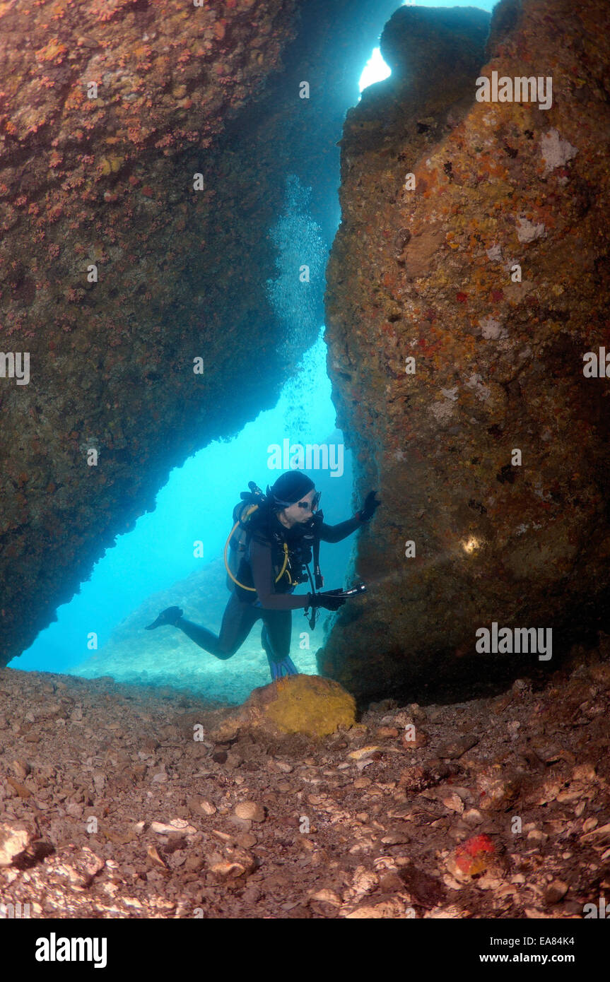 Diver looking into the cave. Bohol Sea,Philippines, Southeast Asia ...