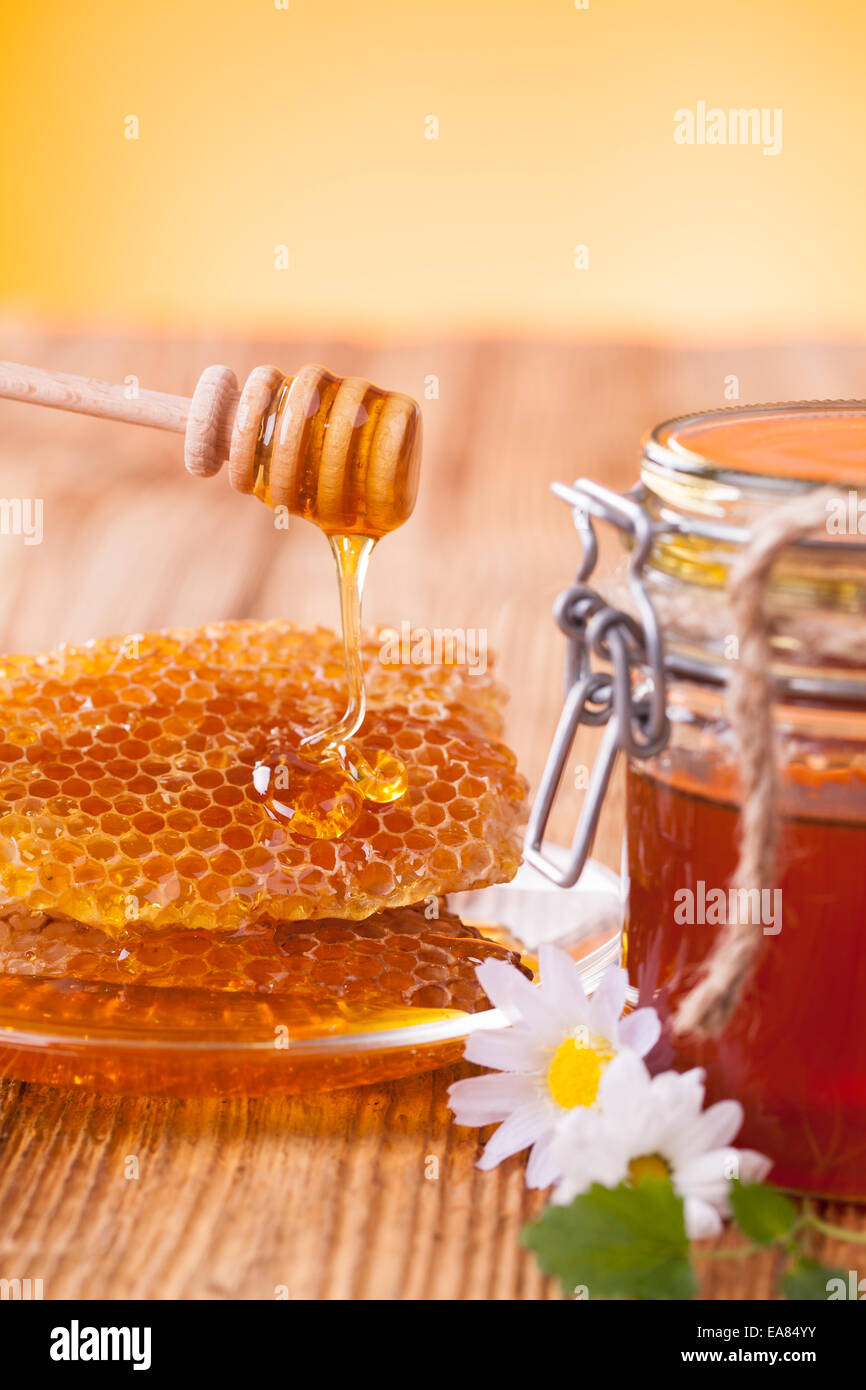 Still life of honey on wooden table Stock Photo - Alamy