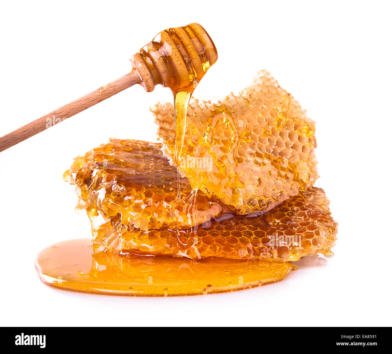 Studio shot of honeycomb and drizzler, isolated on white background ...