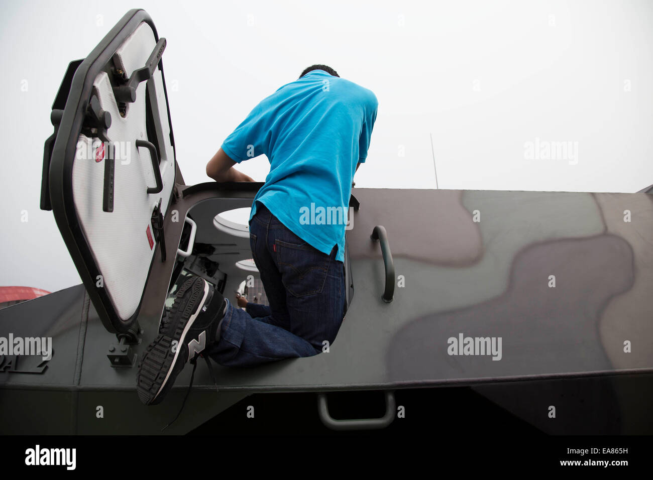 A visitor try to look the inside of an Indonesian Humvee. Indonesia ...