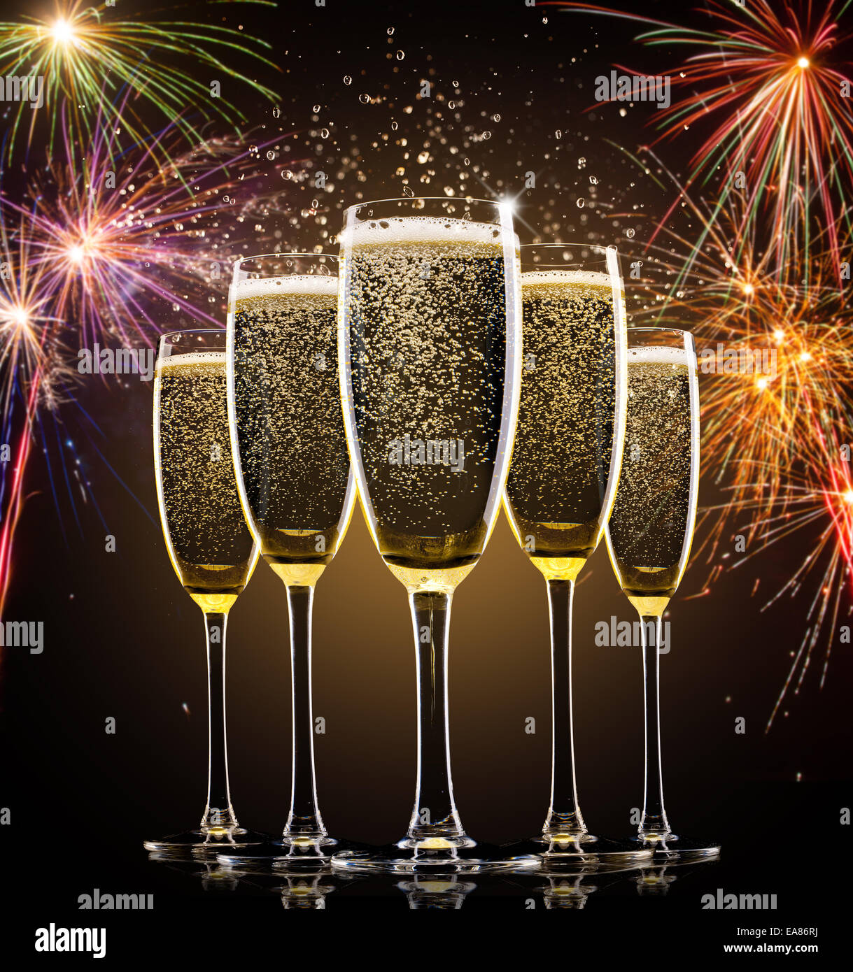 Glasses of champagne with firework on background Stock Photo - Alamy