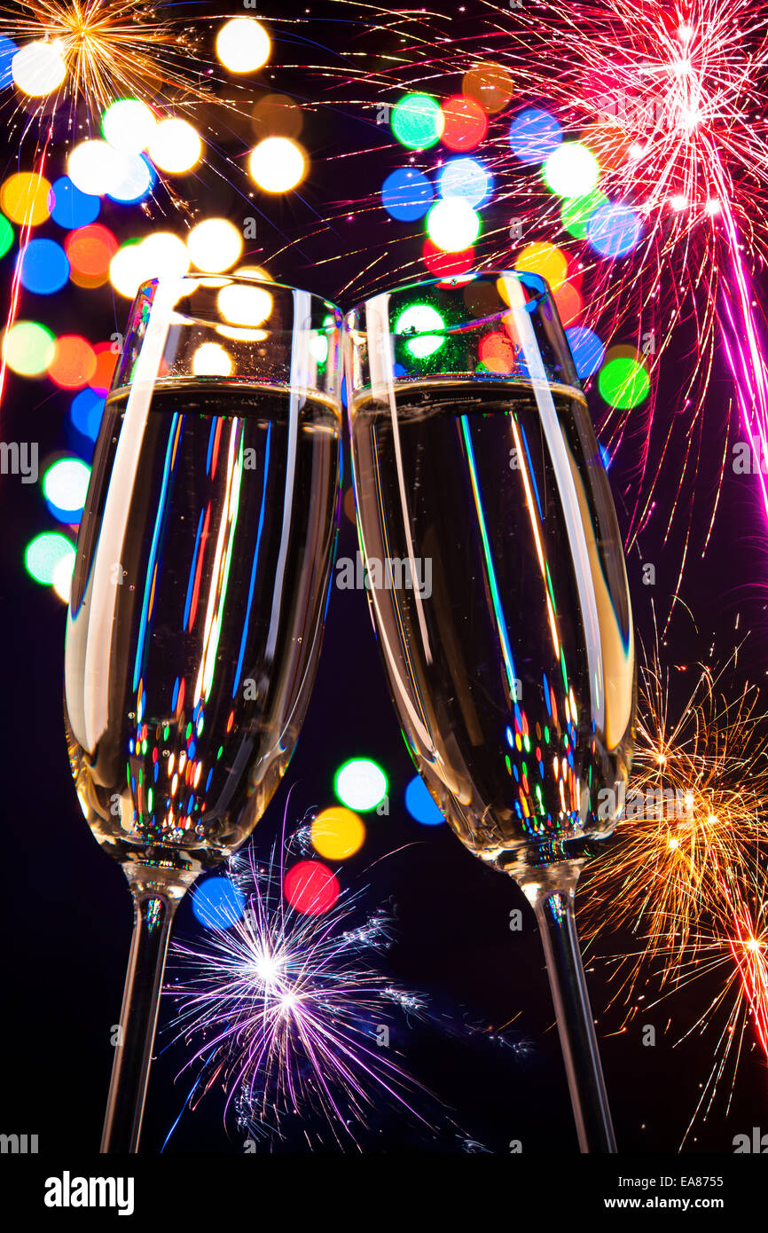 Champagne glasses with fireworks on background Stock Photo - Alamy