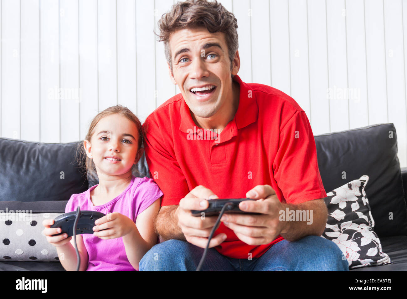 father and daughter playing video game Stock Photo - Alamy