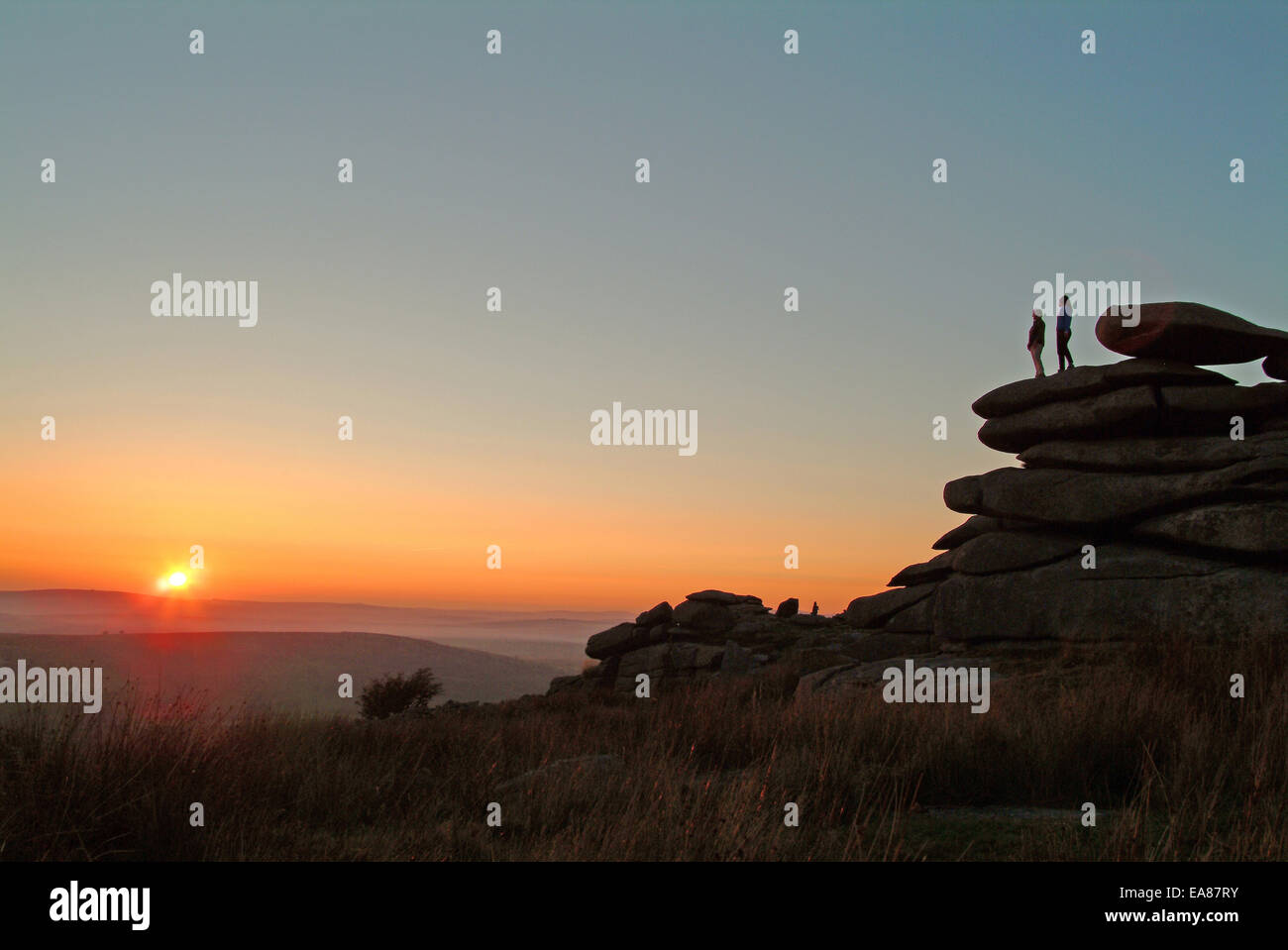 Couple standing on top of Stowes Hill rock formation enjoying the ...