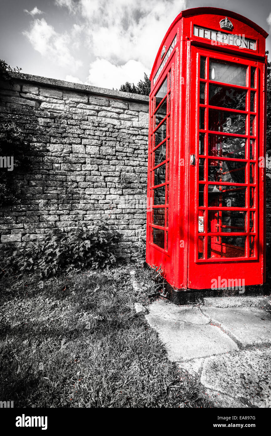 Traditional red telephone box booth or public payphone, village Bibury ...