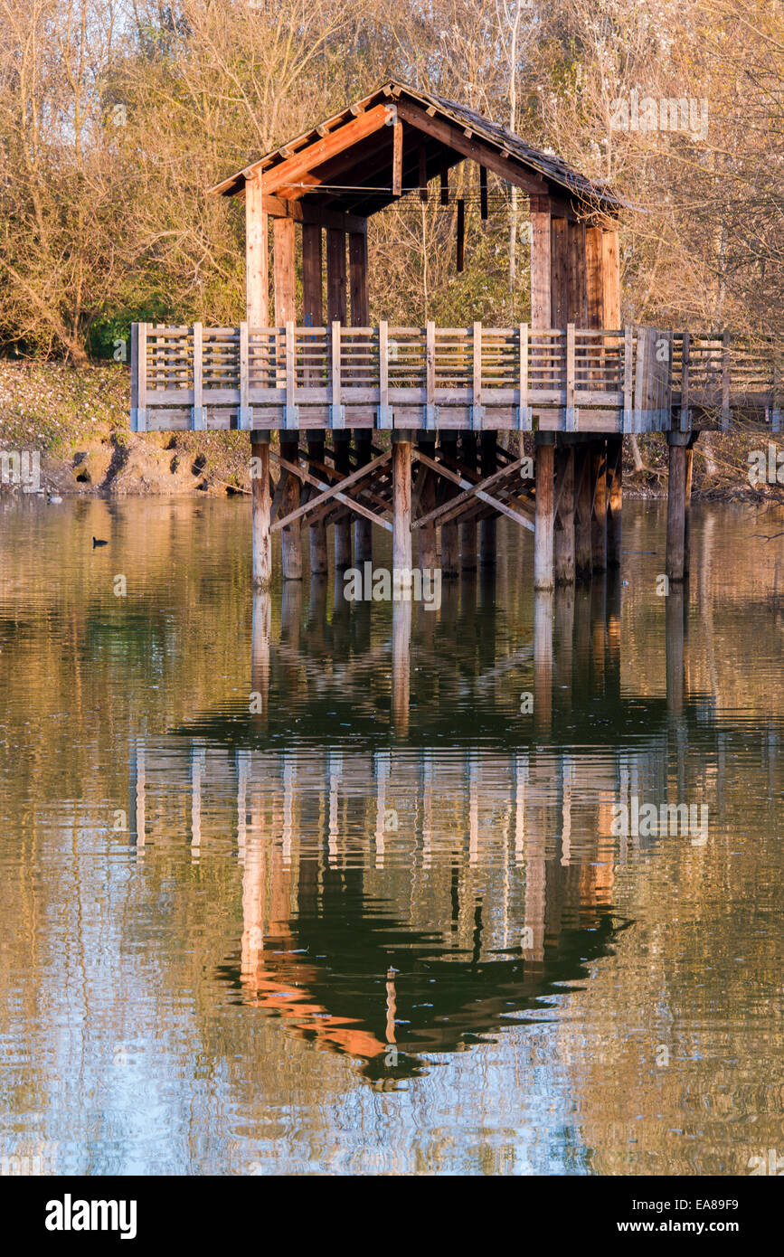 A beautiful wooden palafitte standing upon the calm water of a lake ...