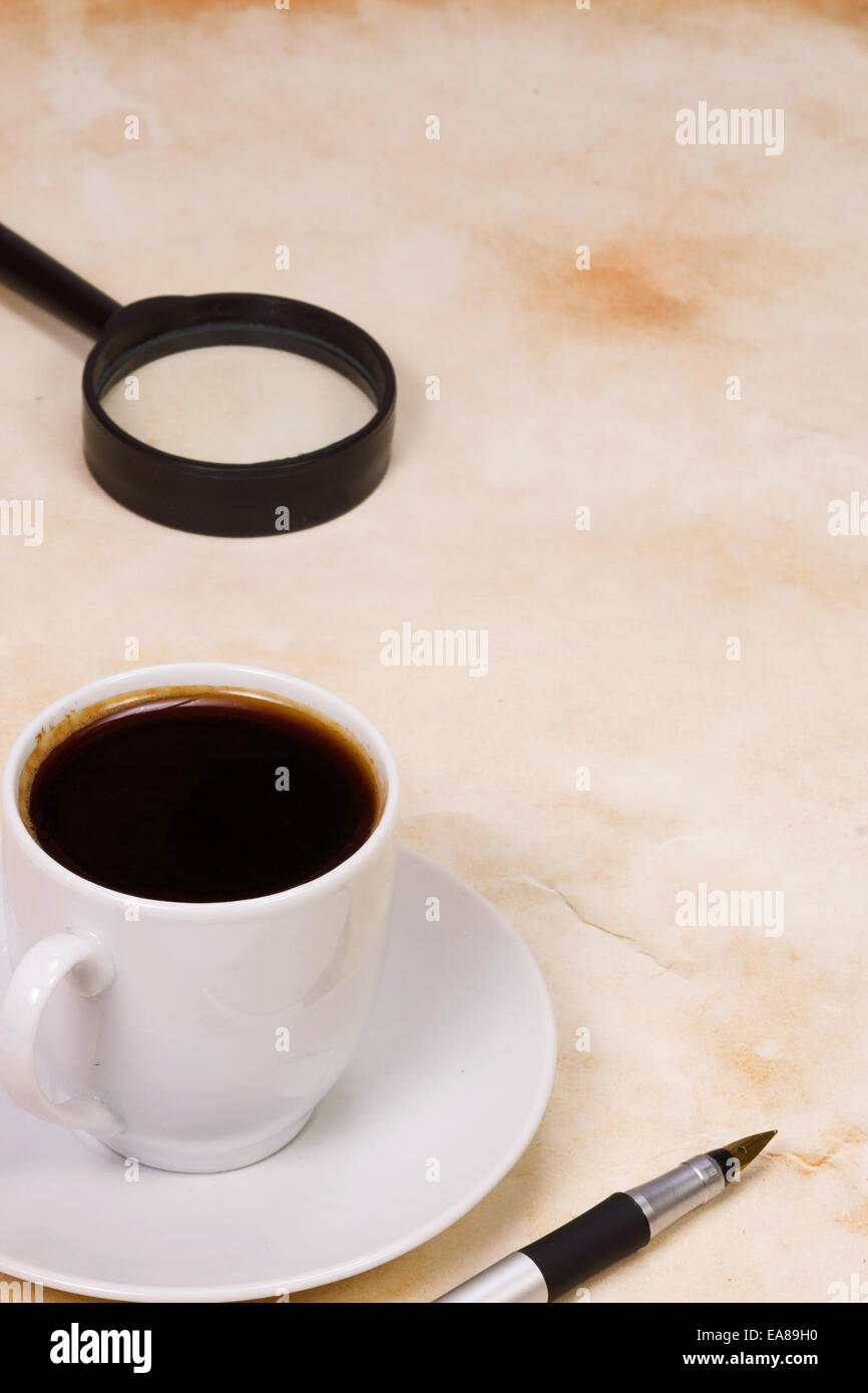 magnifier and cup of coffee at texture Stock Photo - Alamy