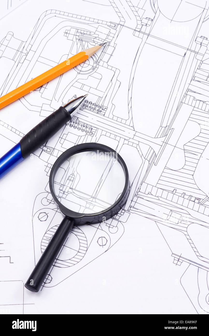 several pens and magnifier and on draft Stock Photo - Alamy