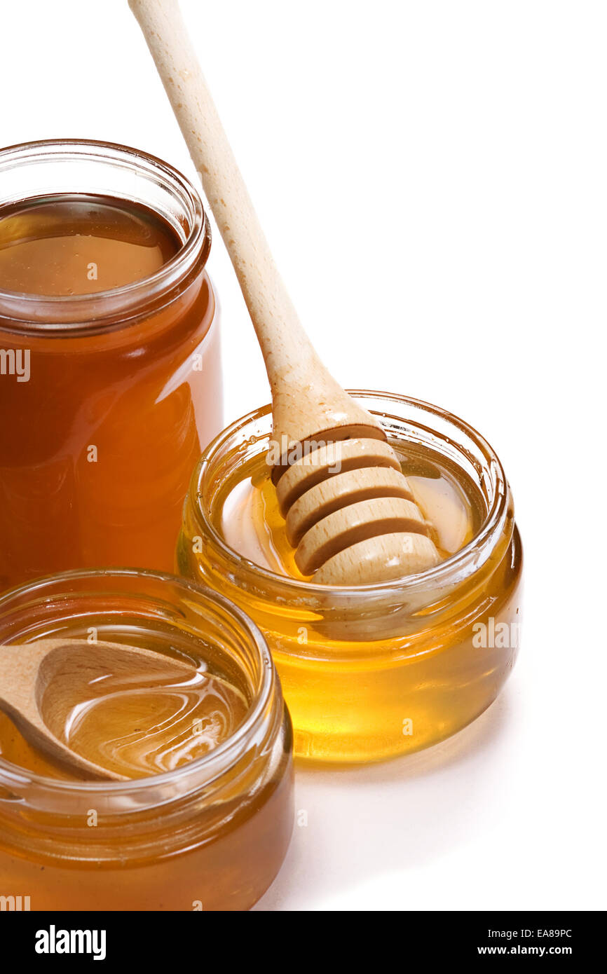 several glass pots with honey Stock Photo - Alamy