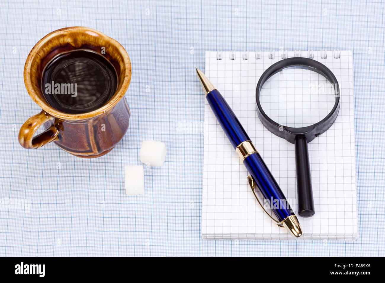 magnifying glass at paper and coffee Stock Photo - Alamy