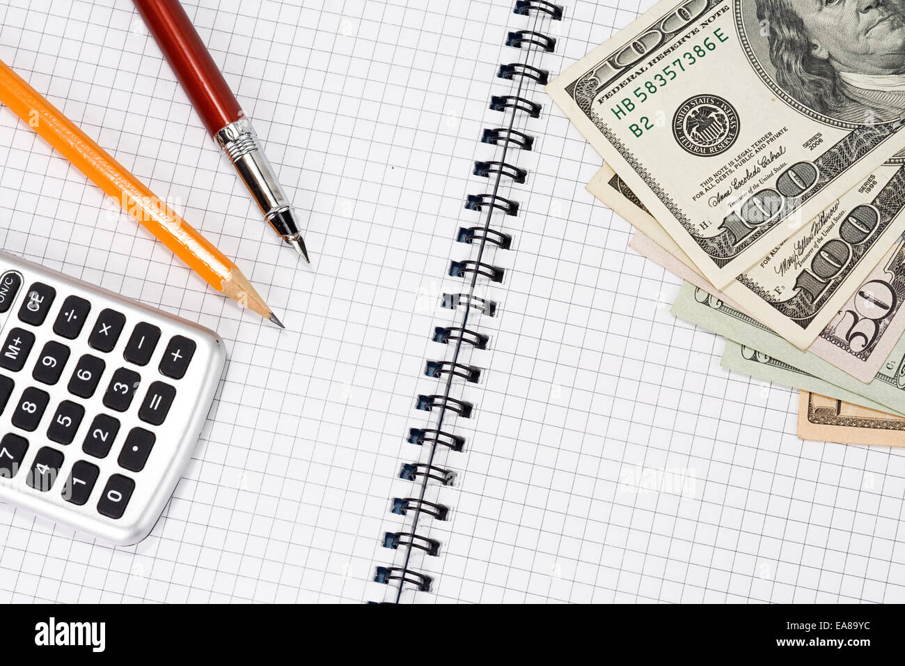 dollars, pen and pencil on pad Stock Photo - Alamy
