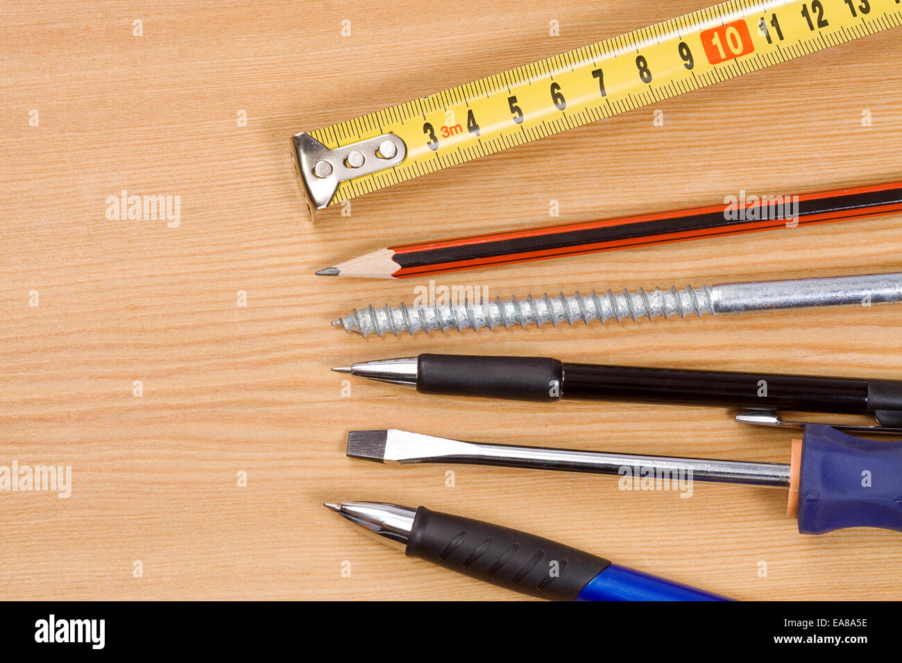 pen, pencil and tape measure on wood table Stock Photo - Alamy