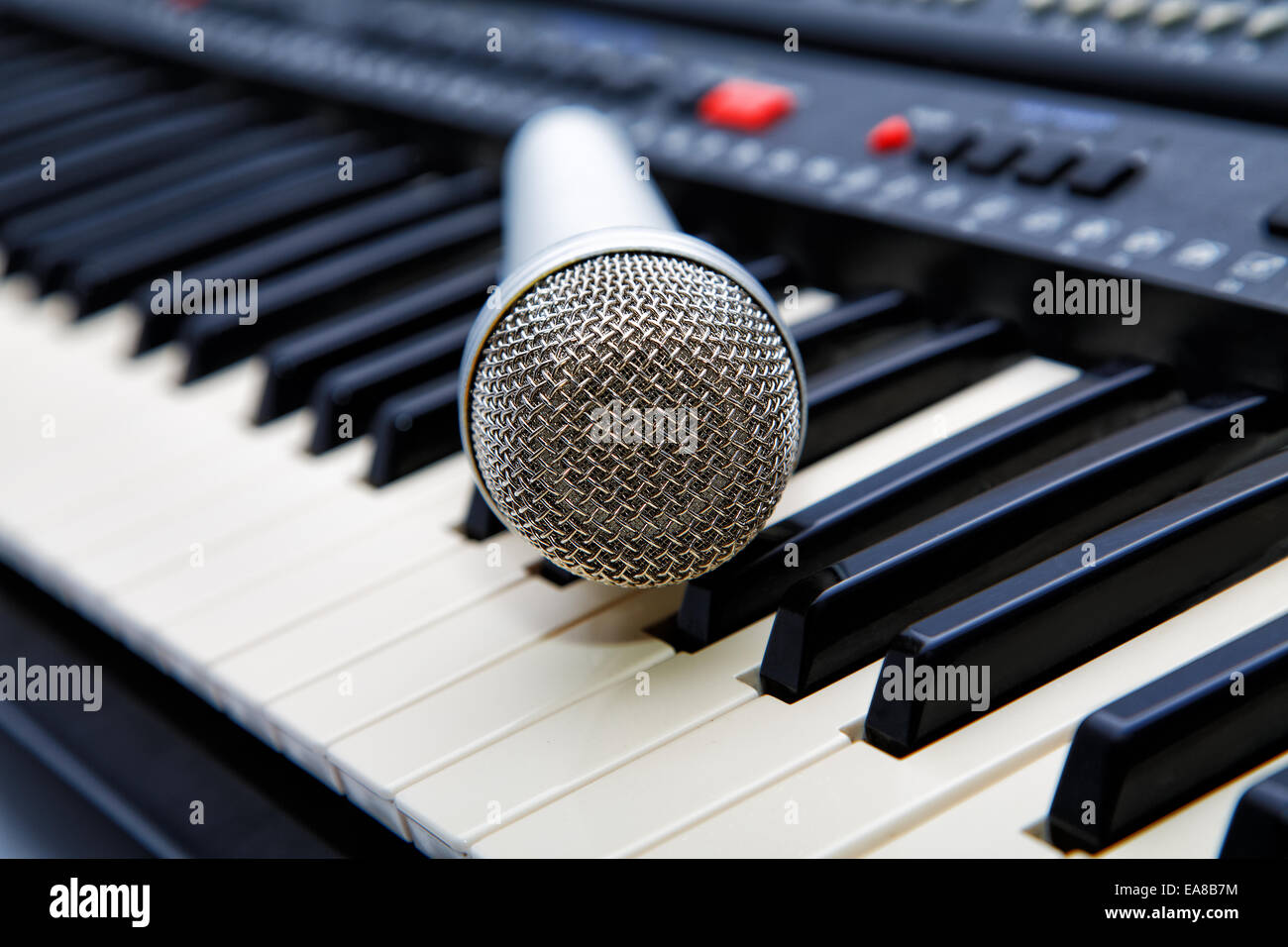 The microphone lies on the synthesizer keyboard Stock Photo - Alamy