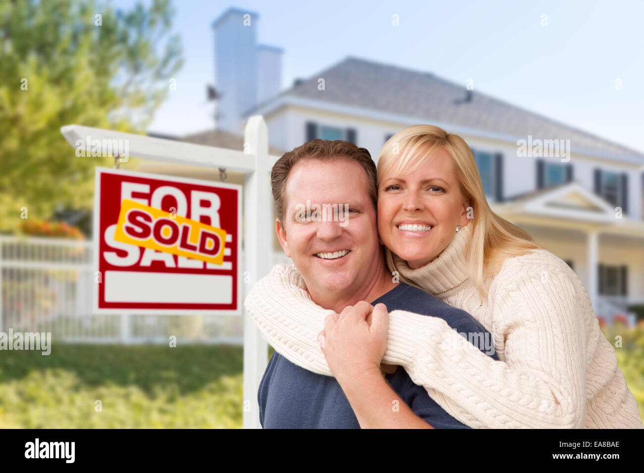 Affectionate Happy Couple in Front of New House and Sold For Sale Real ...