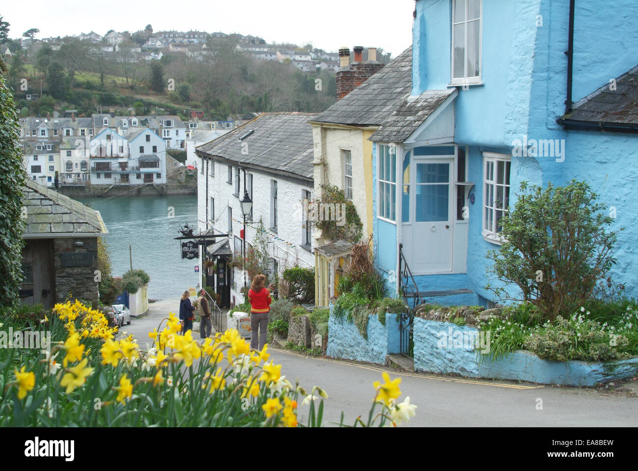 Woman in red & couple walking down the road at Bodinnick with view ...