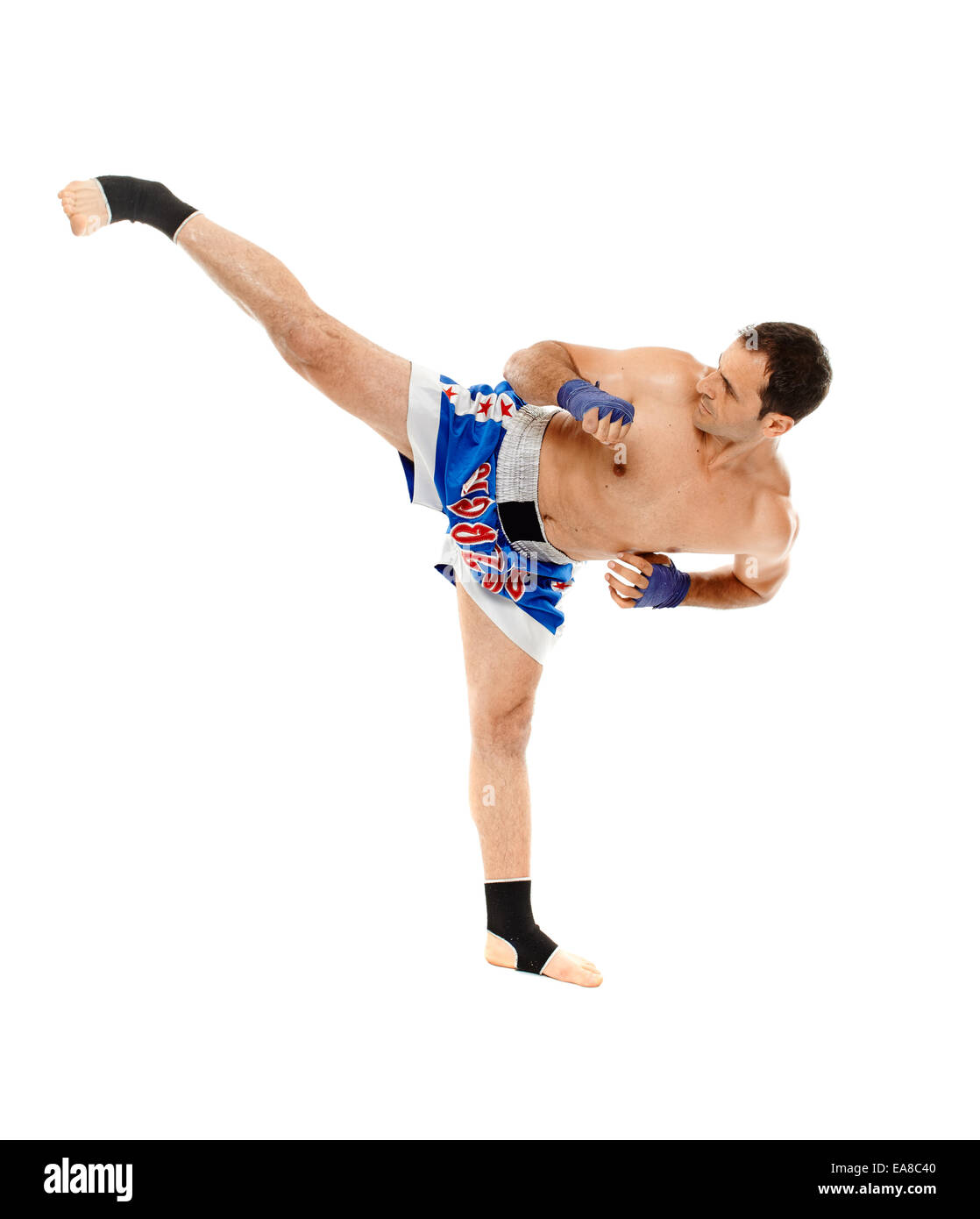 Muay thai or kickboxer executing a powerful kick, isolated on white ...
