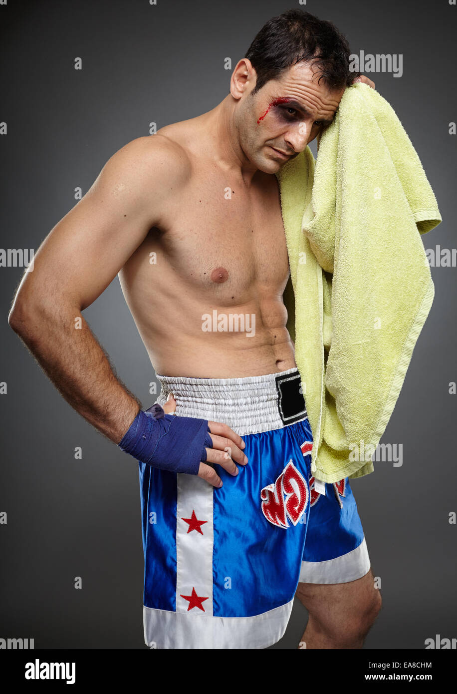 Bruised and injured fighter with towel after a difficult match Stock ...