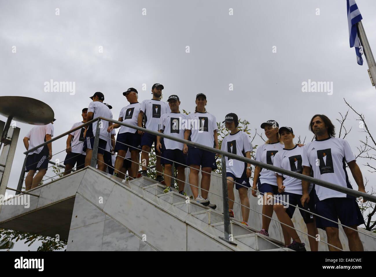 The torch bearers line up on the steps that lead up to the Marathon ...