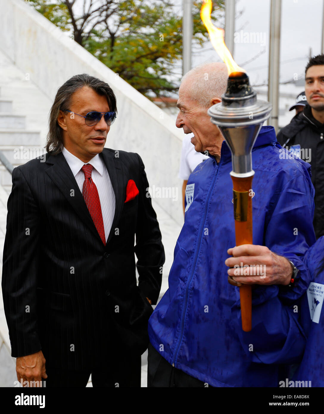 The mayor of Marathon, Ilias Psinakis (left), talks with George Hirsch ...