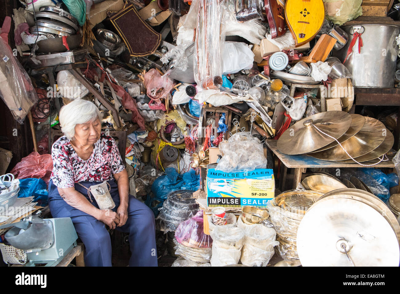 Saleswoman with disorganized stock of hardware goods hi-res stock ...