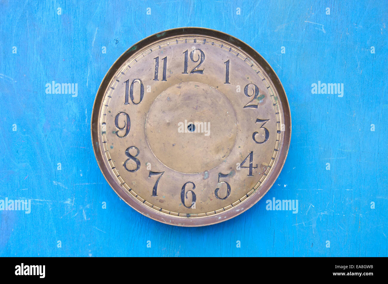 ancient brass clock face dial on blue background Stock Photo - Alamy