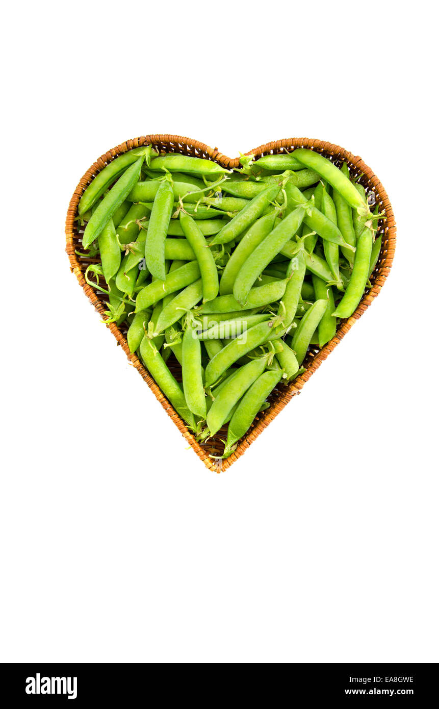 fresh pea pods in heart form wicker basket isolated on white Stock ...