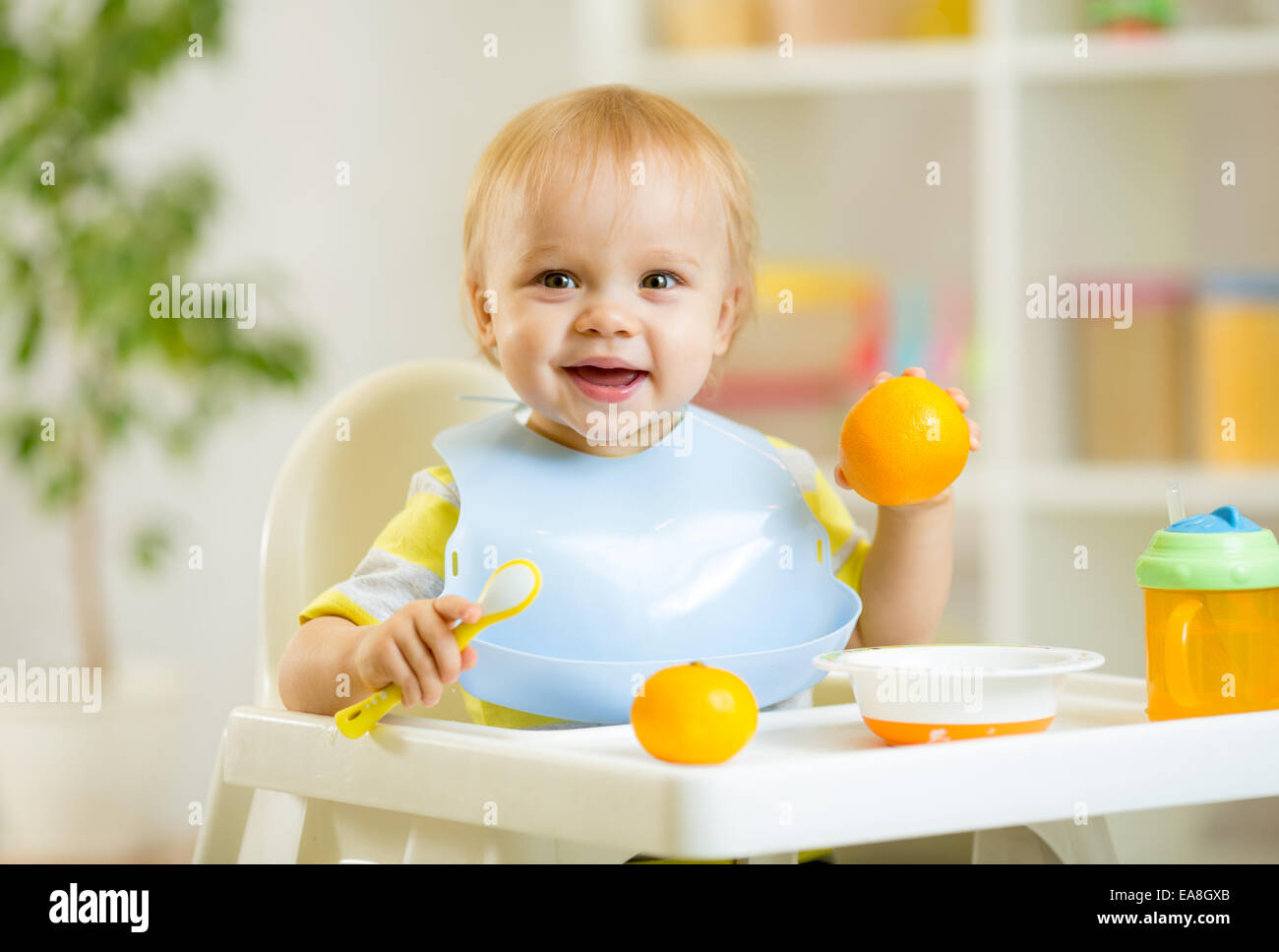 happy baby kid boy eating healthy food Stock Photo - Alamy