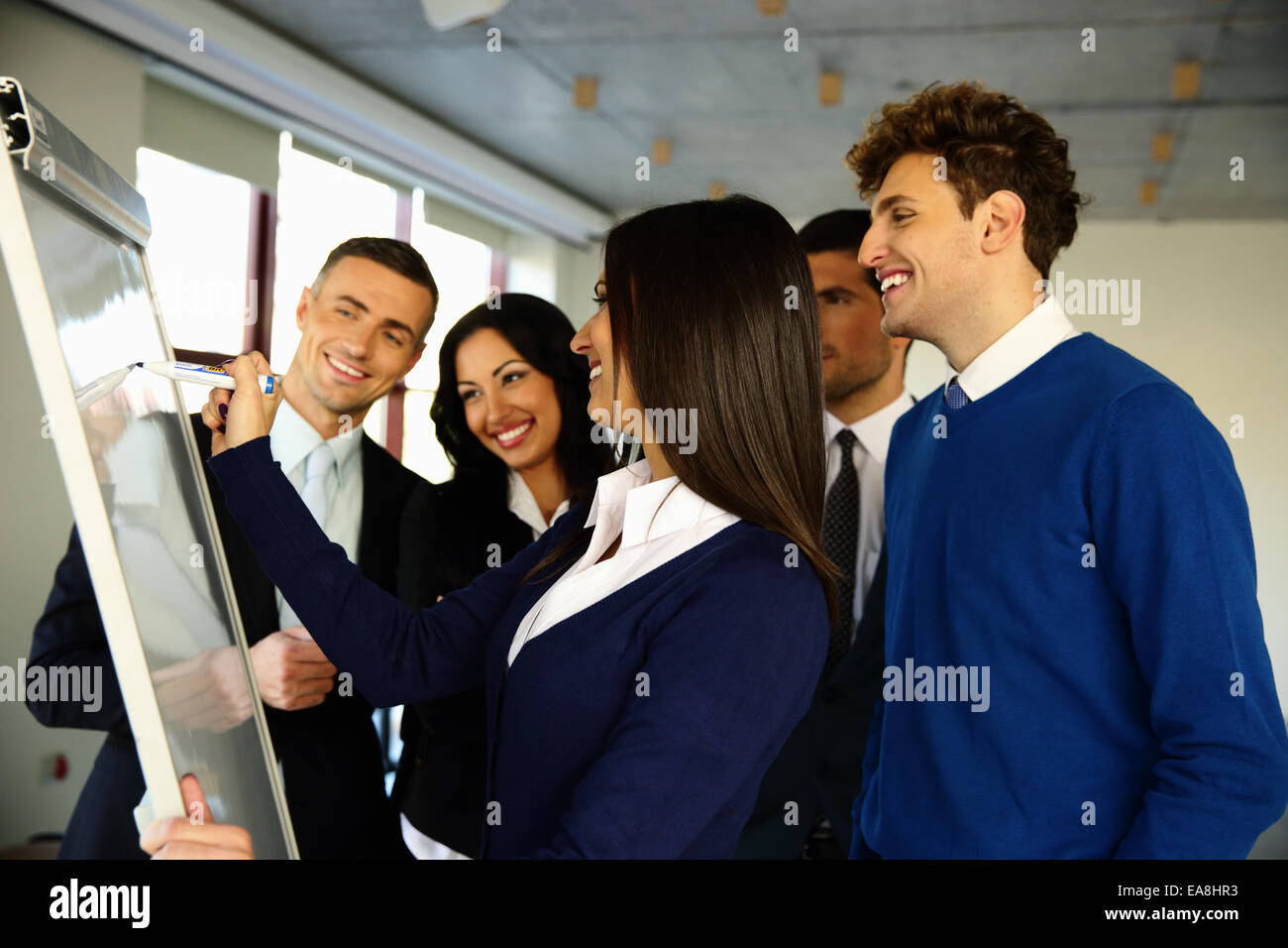 Happy business team with flip board in office Stock Photo - Alamy
