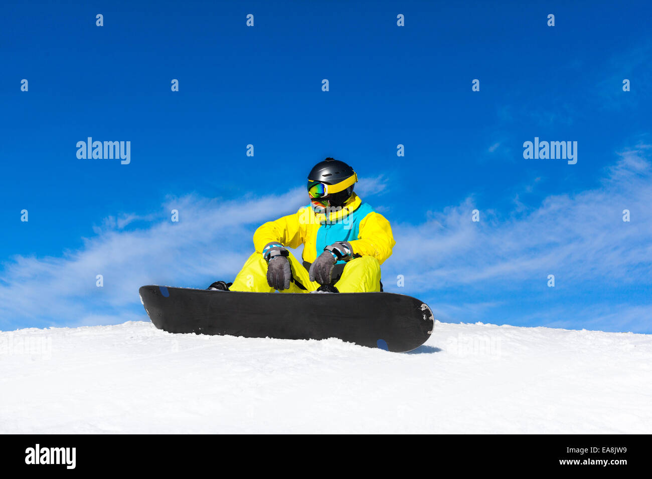 snowboarder sitting on snow mountain slope Stock Photo - Alamy
