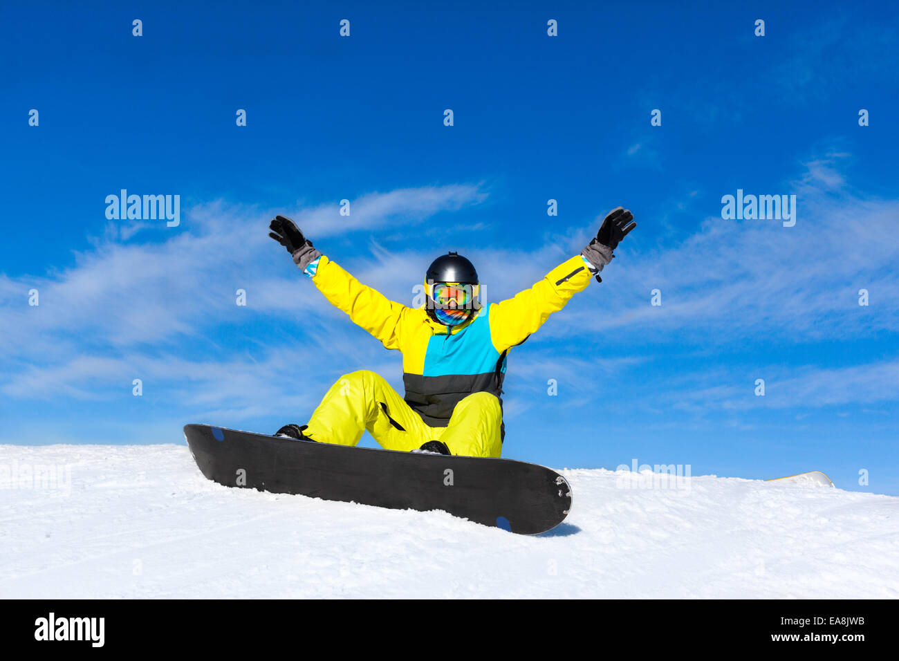 snowboarder excited happy raised arms hands up sitting on snow Stock ...
