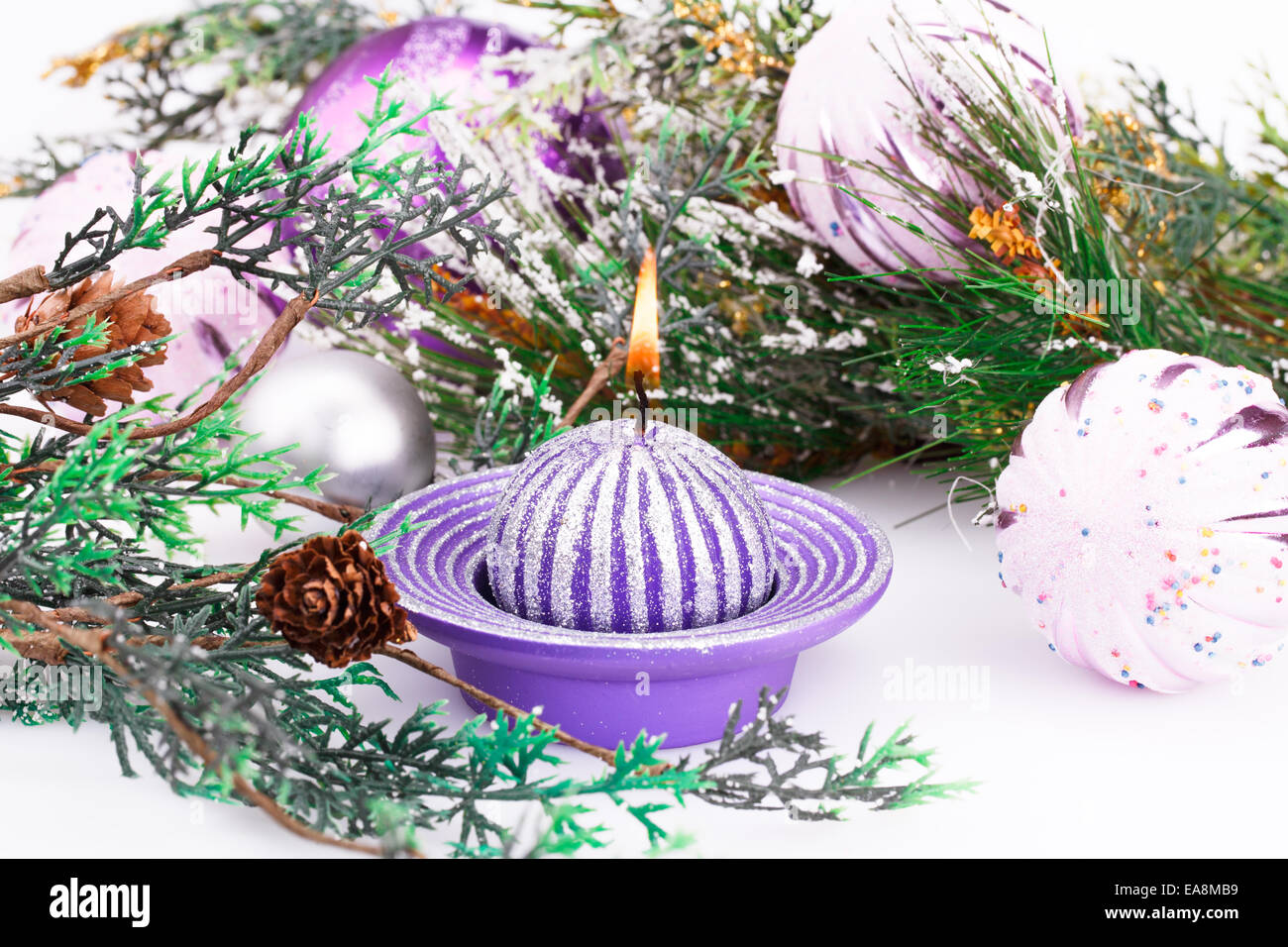Christmas pink balls, candle and fir tree on gray background Stock ...
