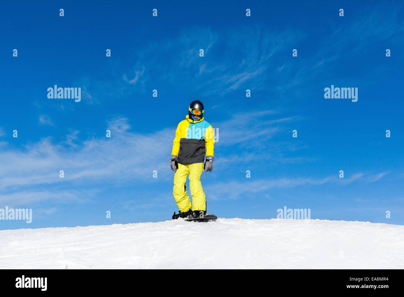 Snowboarder sliding down the hill Stock Photo - Alamy