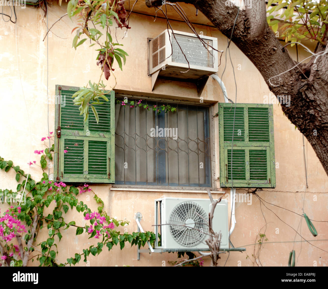 Old and new air-conditioning unites arranged around a window Stock ...
