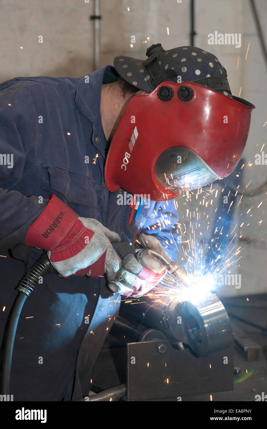 Engineer welding a metal part Stock Photo - Alamy