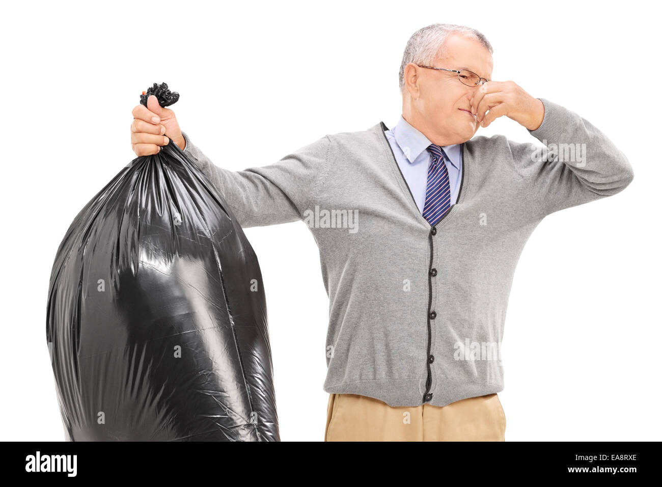 Senior holding a stinky garbage bag isolated on white background Stock ...