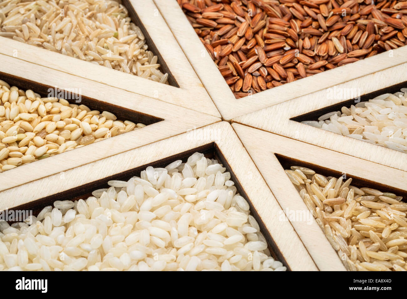 rice grain variety - triangle abstract in a wooden tray Stock Photo - Alamy