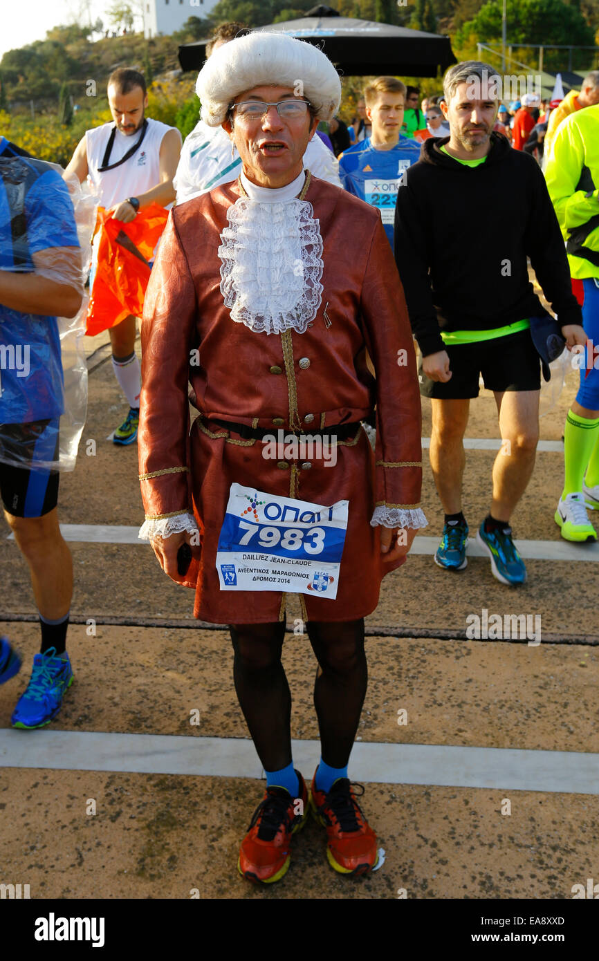 A runner poses in an historical costume before the start of the Athens ...