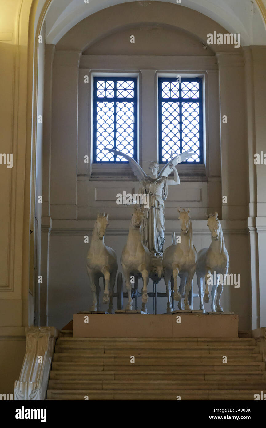 A huge sculpture of a chariot pulled by four horses with a standing ...