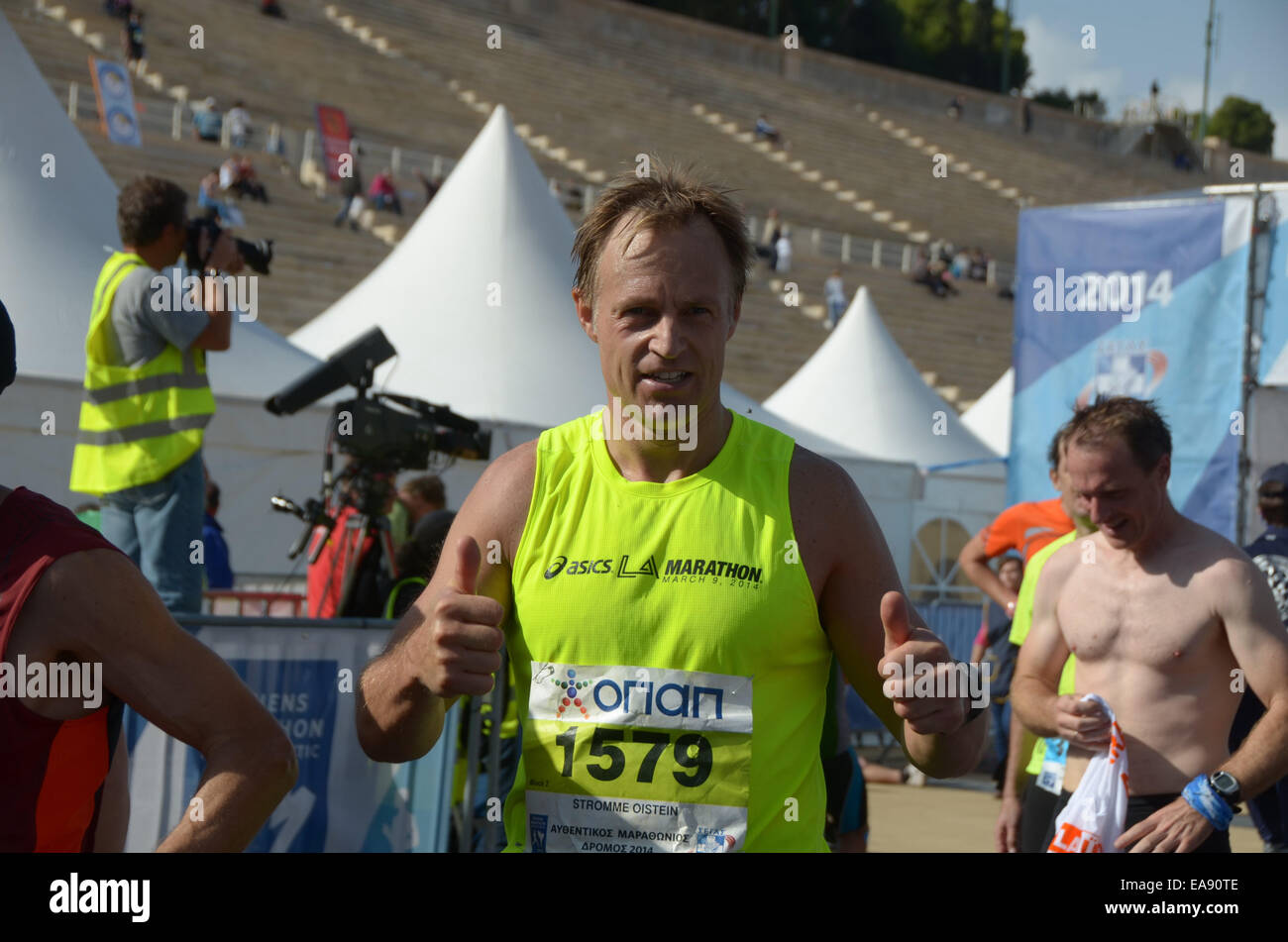 An exhausted Marathon runner poses for the camera after finishing the ...
