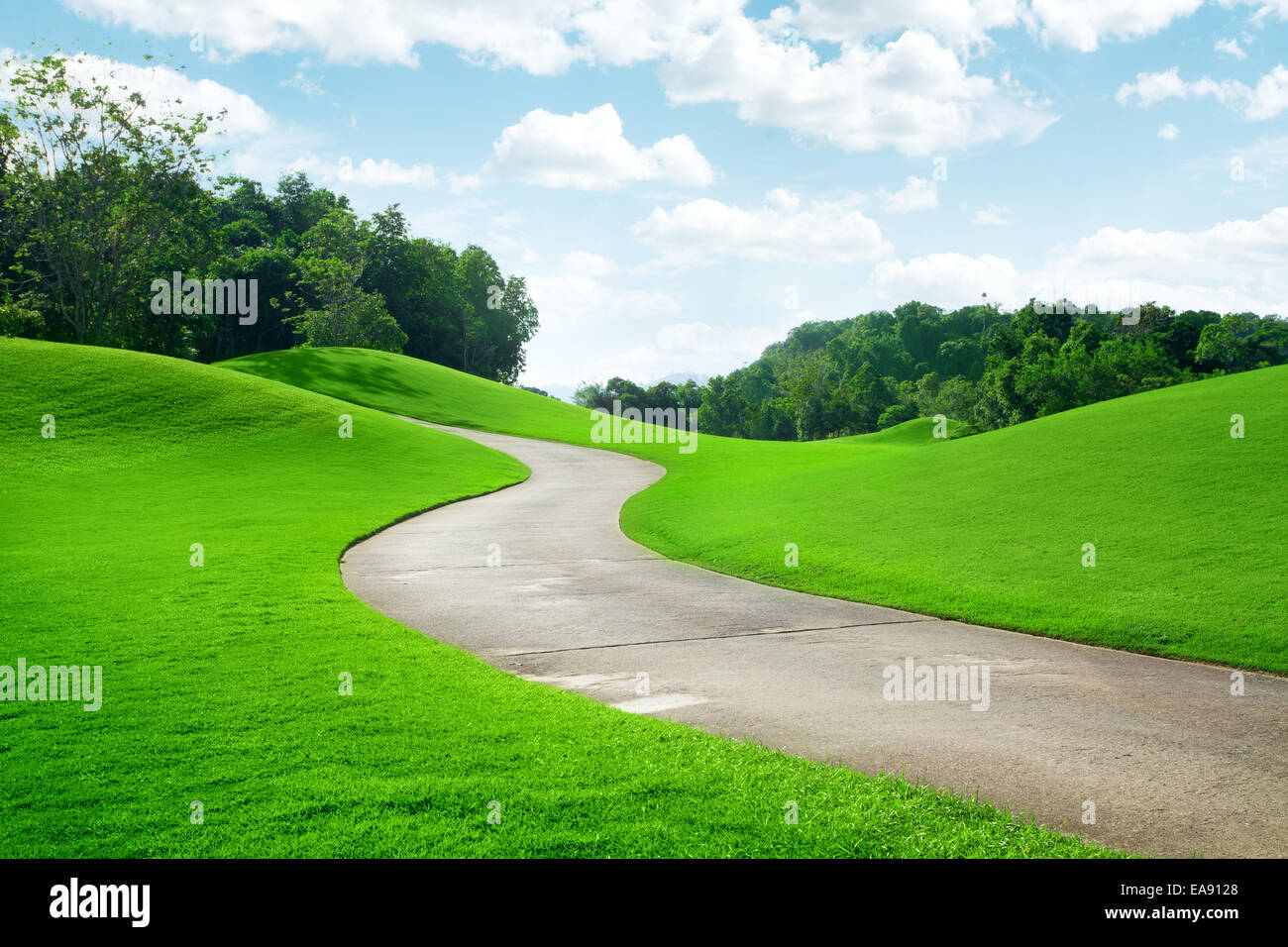 panoramic view of nice green hill and path on blue sky background Stock ...